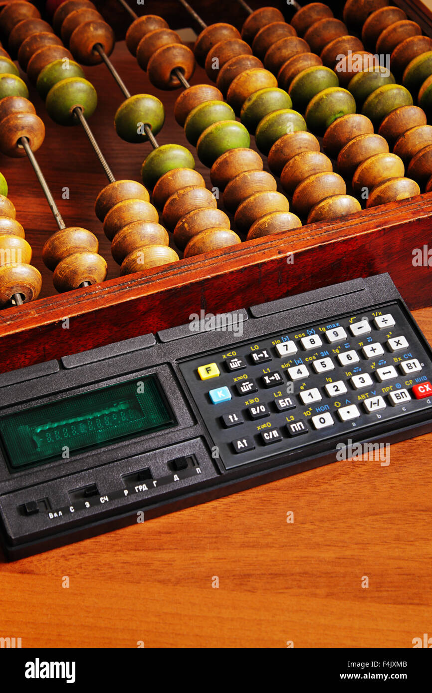 Retro calculators. Wooden abacus and mathematic calculator from 20 ...