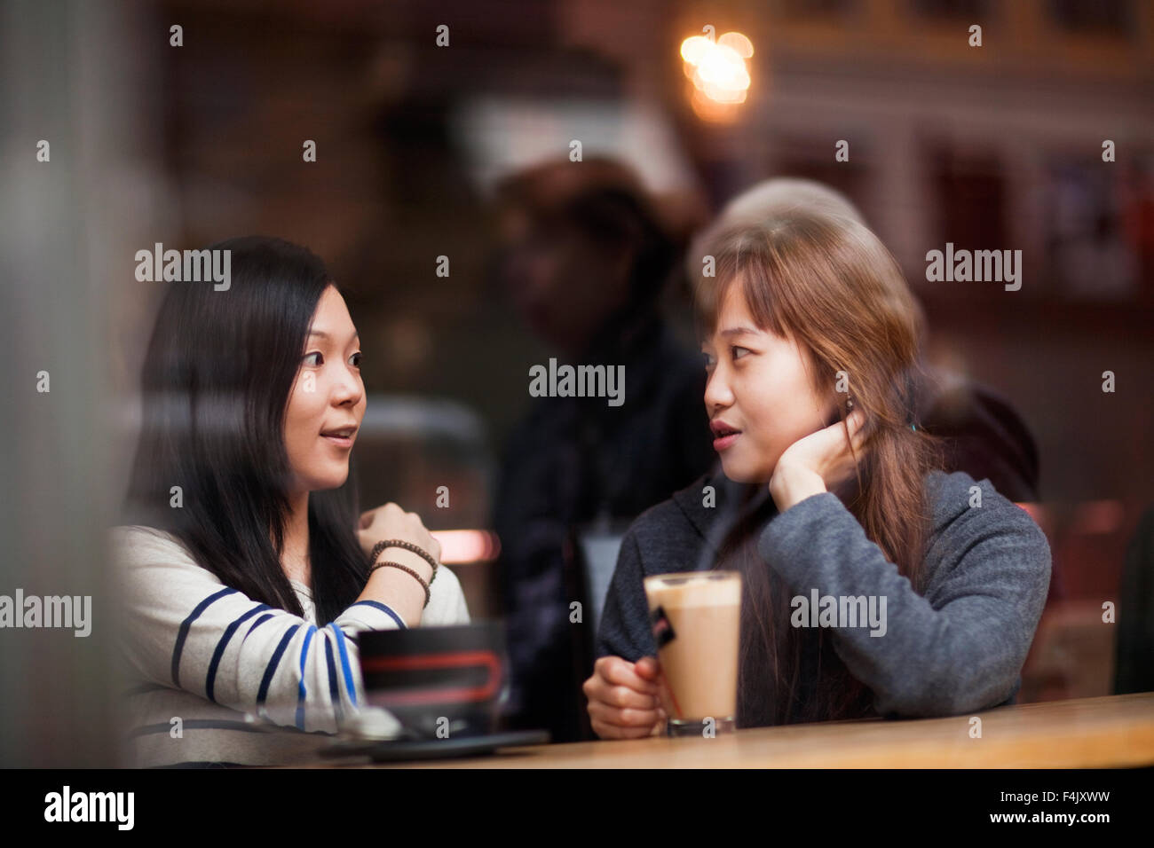 Two young friends in cafe bar Stock Photo - Alamy
