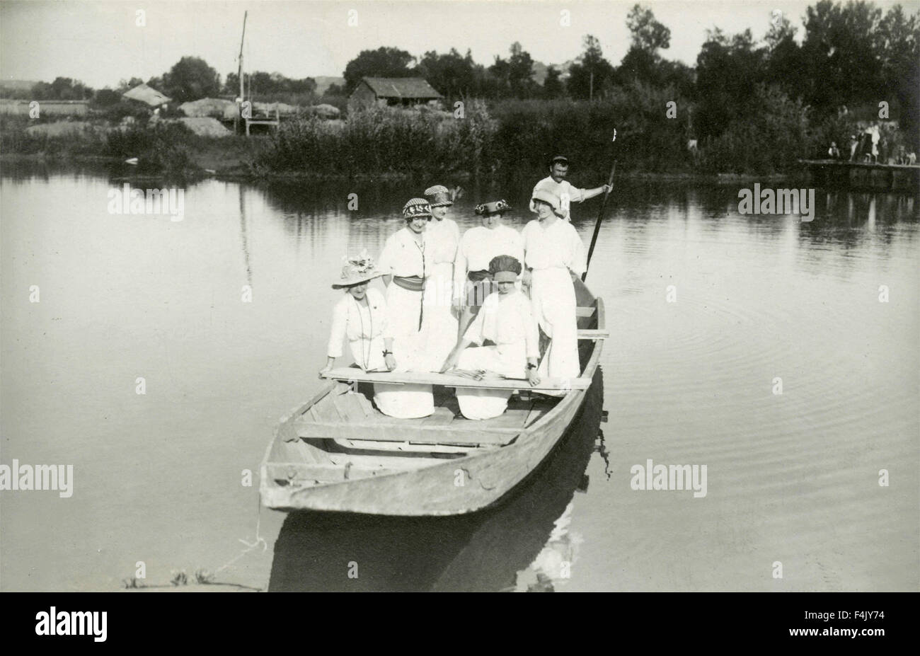 Group women dressed in white in boat on lake hi-res stock photography ...