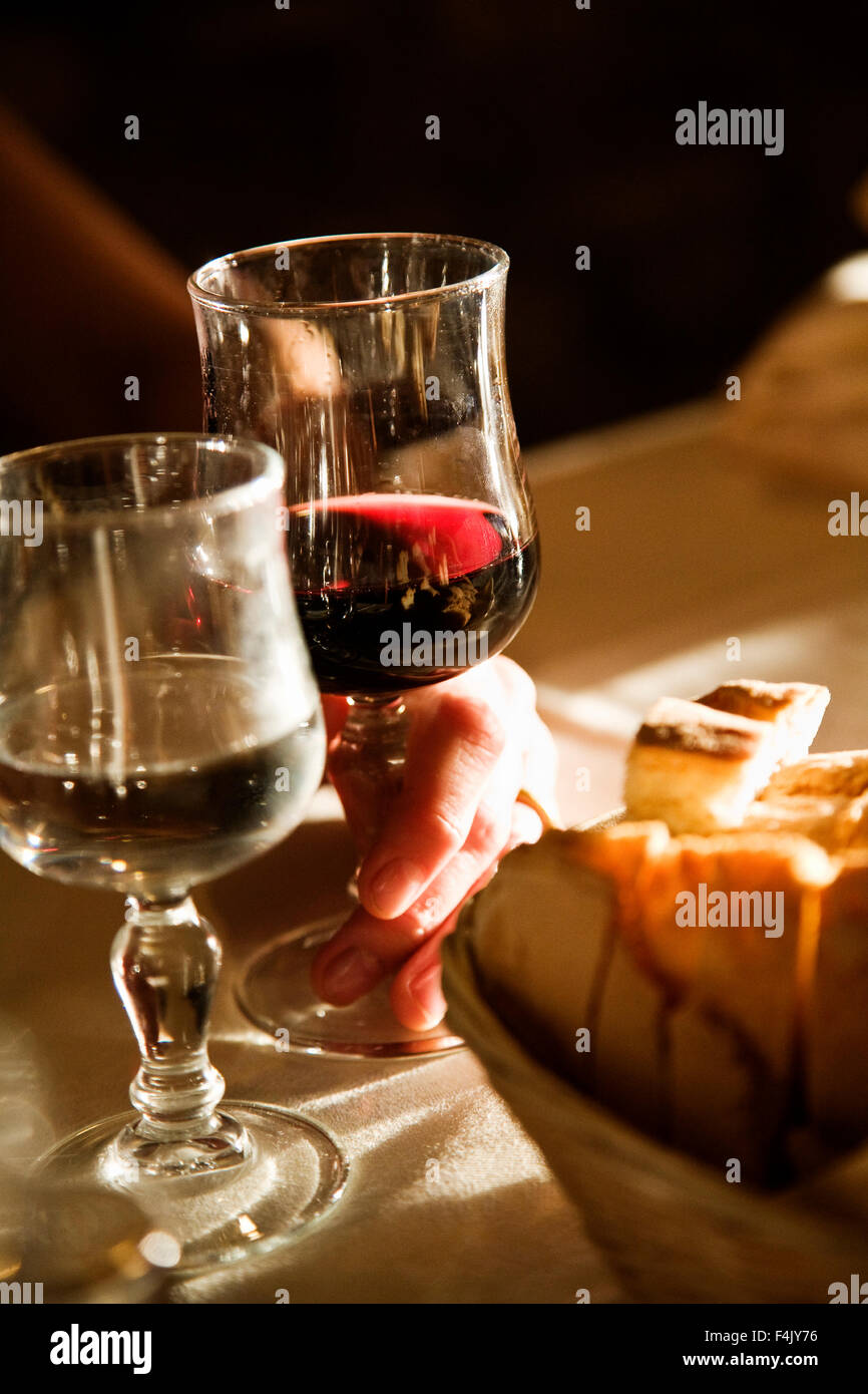 Hand holding glass of wine Stock Photo - Alamy