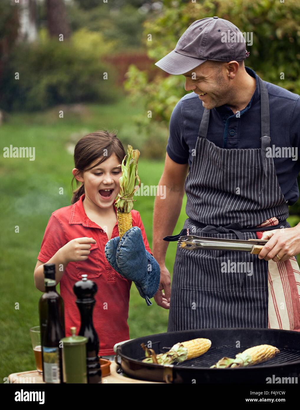 Father and daughter preparing barbecue Stock Photo - Alamy
