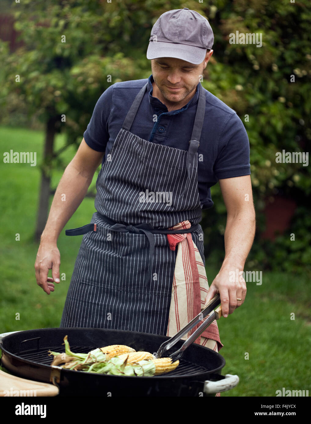 Man with barbecue grill Stock Photo - Alamy