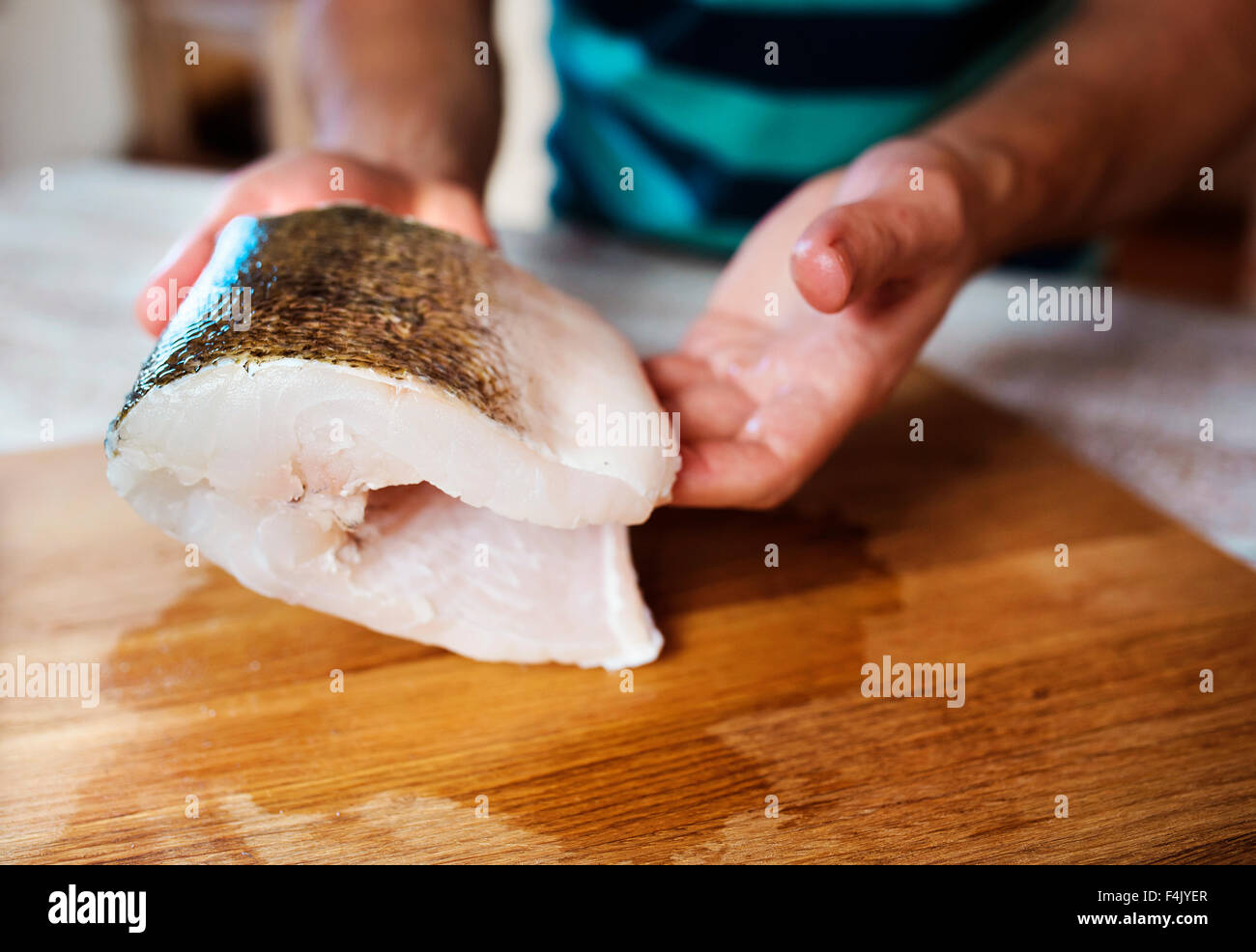Man holding zander fillets Stock Photo - Alamy