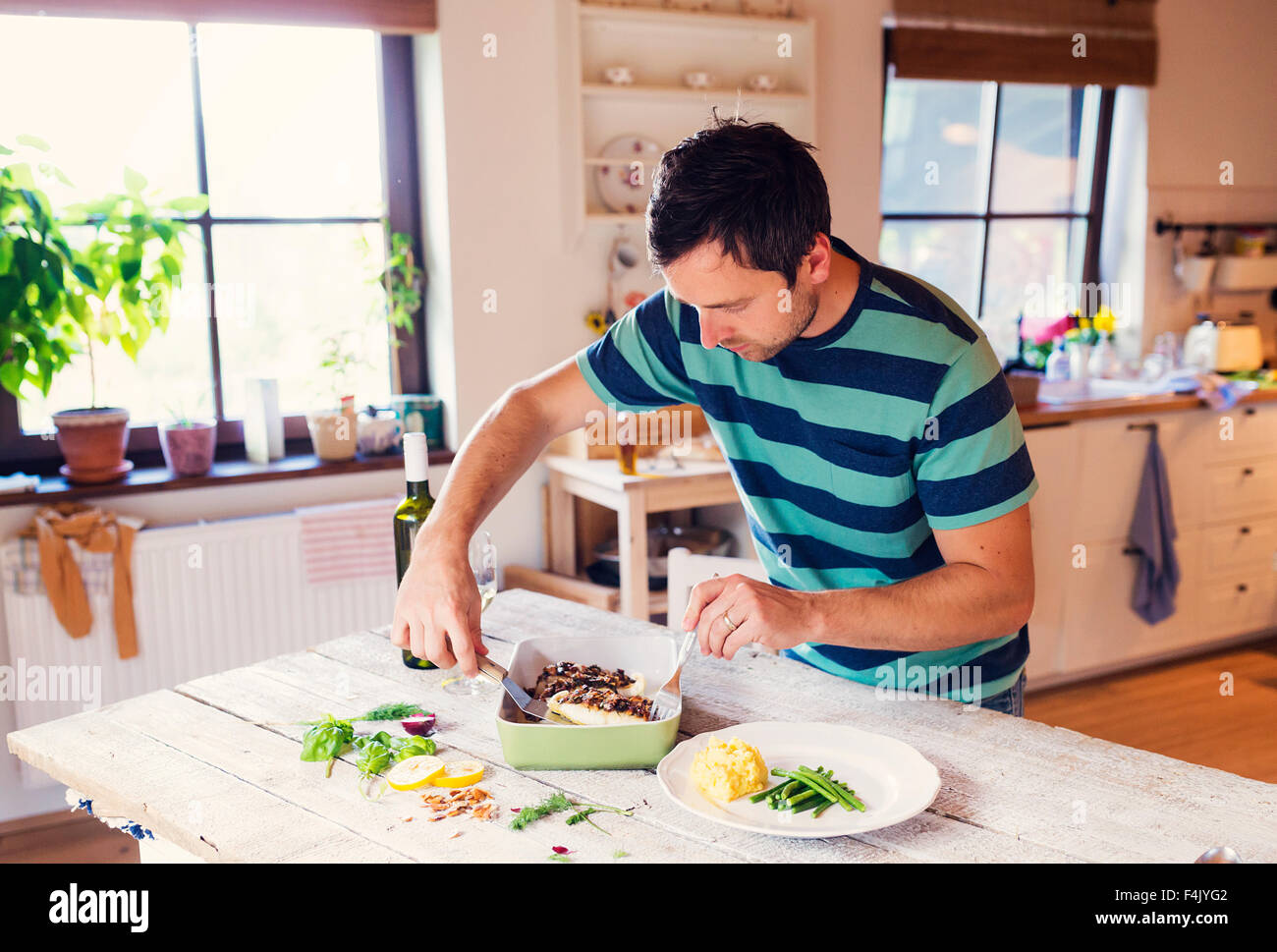 Man serving fish Stock Photo - Alamy