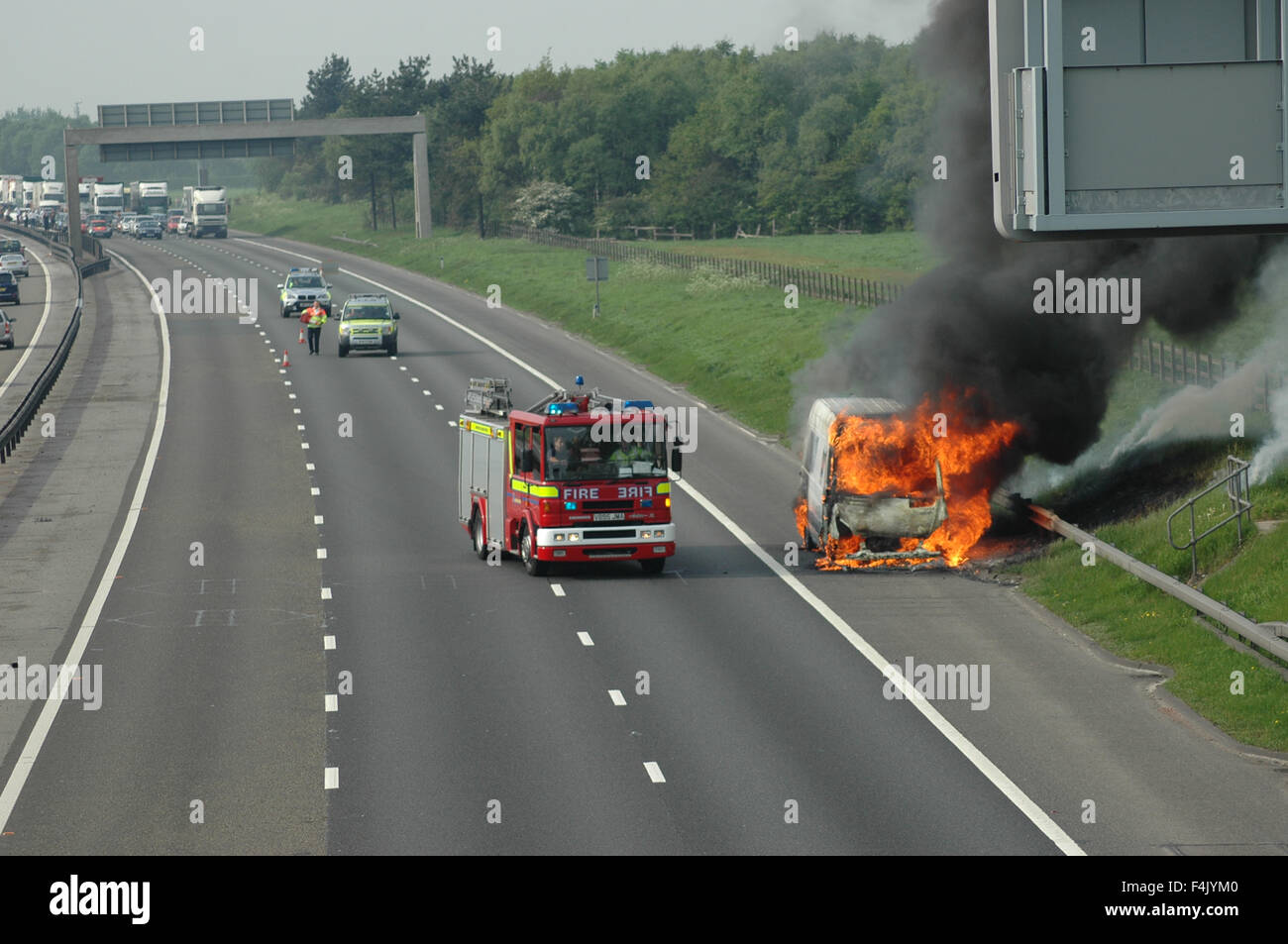 Firemen putting out a van fire on Motorway Stock Photo - Alamy
