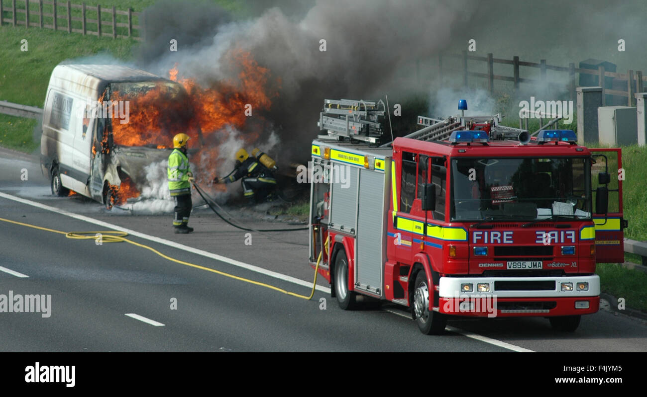 Firemen putting out a van fire on Motorway Stock Photo - Alamy