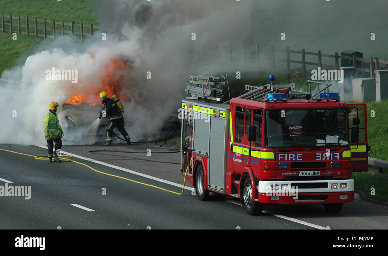 Firemen putting out a van fire on Motorway Stock Photo - Alamy