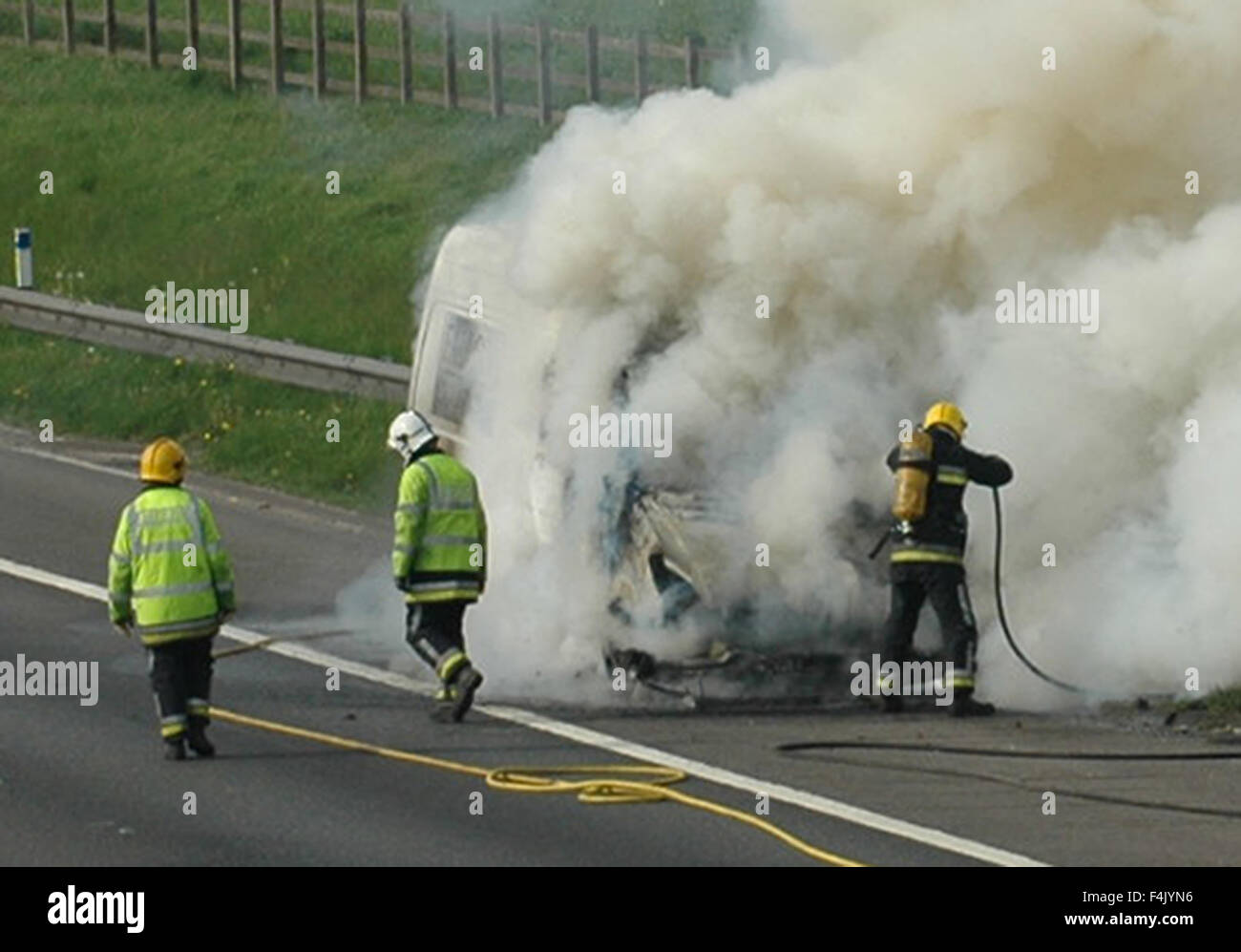 Firemen putting out a van fire on Motorway Stock Photo - Alamy