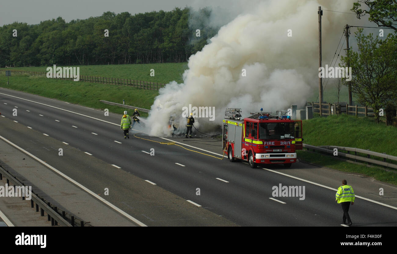 Firemen putting out a van fire on Motorway Stock Photo - Alamy