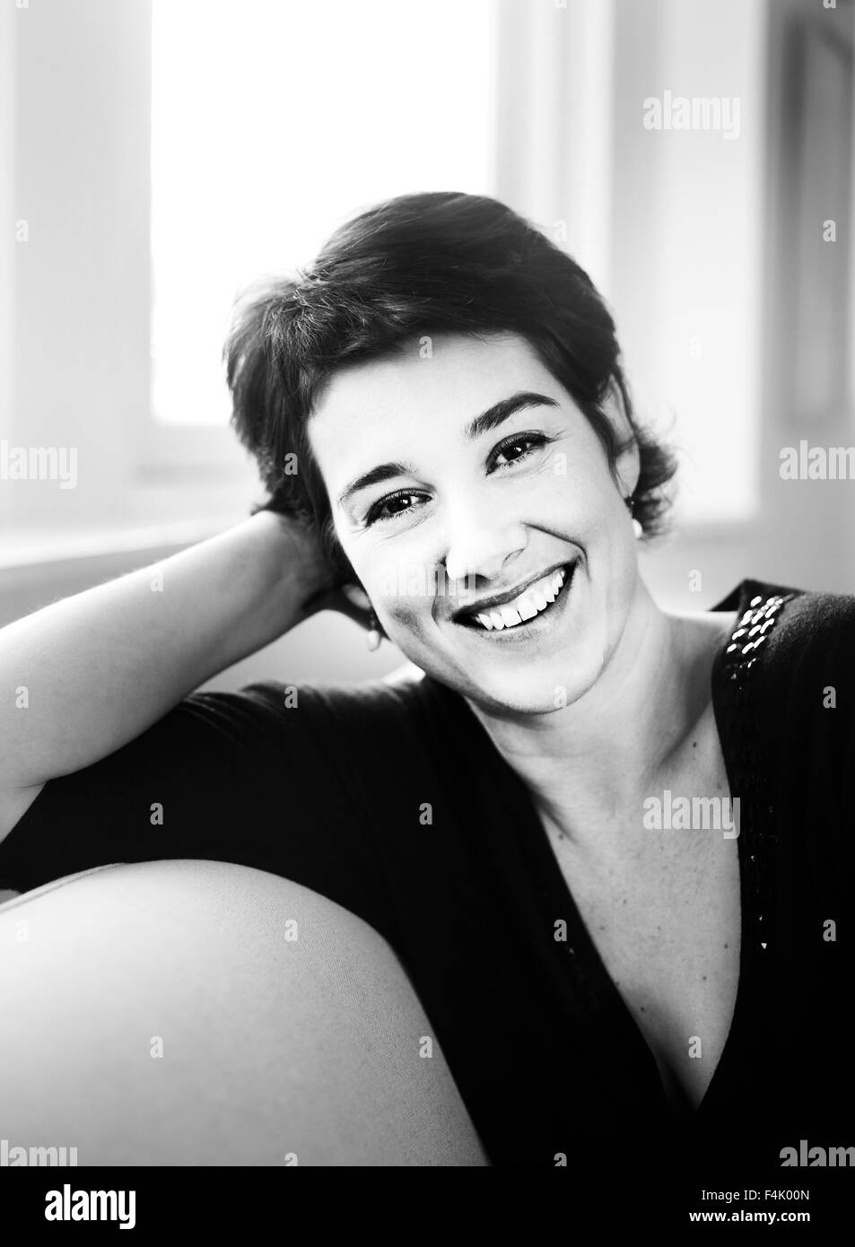 Positive smiling person sitting Black and White Stock Photos & Images ...