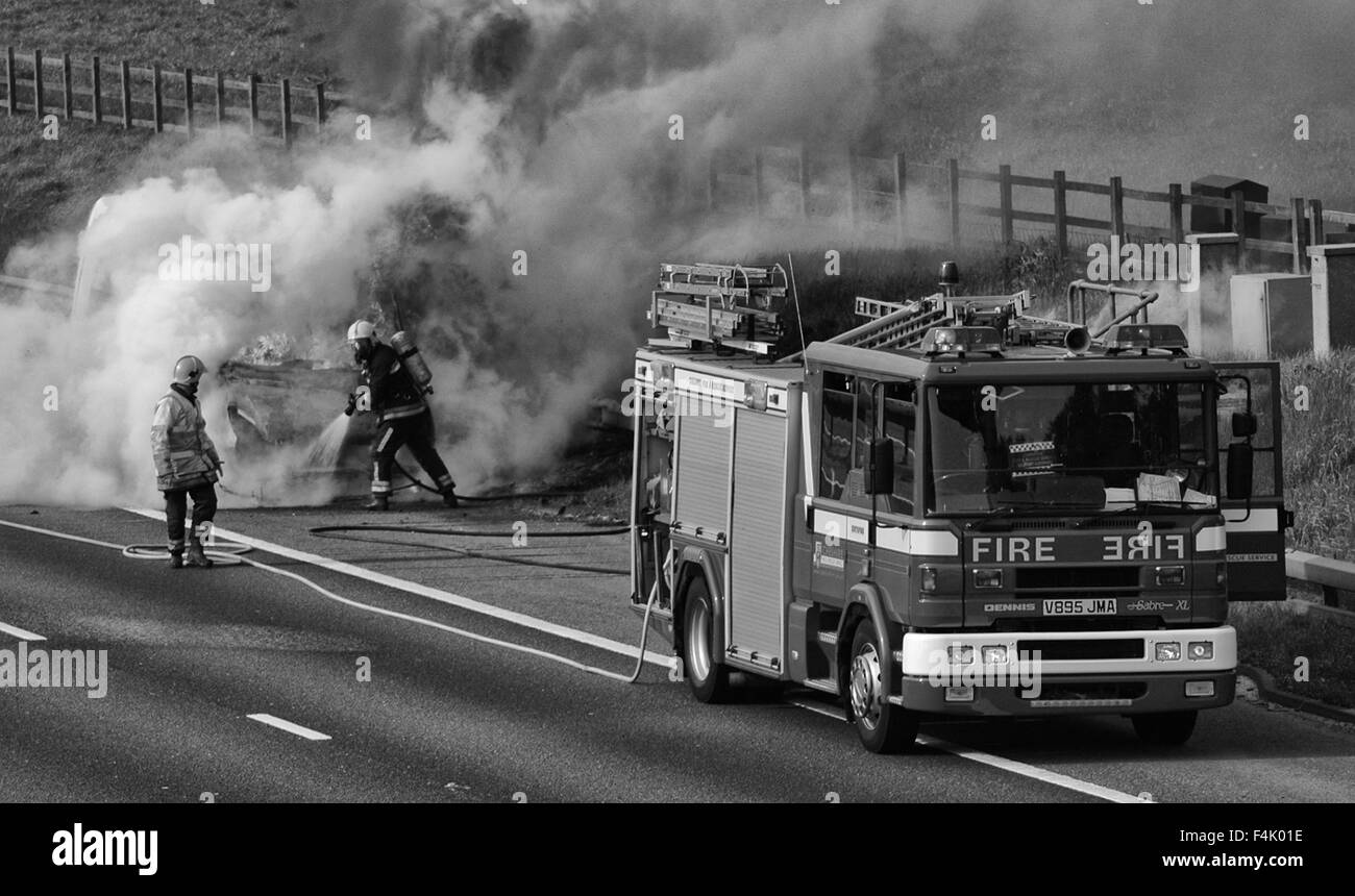 Firemen putting out a van fire on Motorway Stock Photo - Alamy