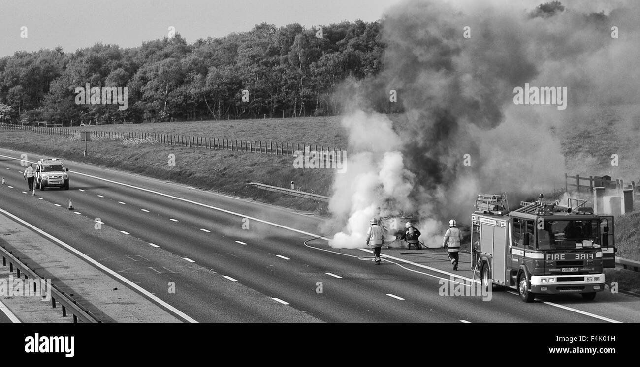 Firemen putting out a van fire on Motorway Stock Photo - Alamy