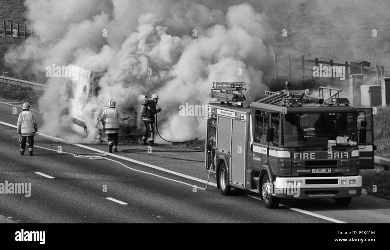 Firemen putting out a van fire on Motorway Stock Photo - Alamy