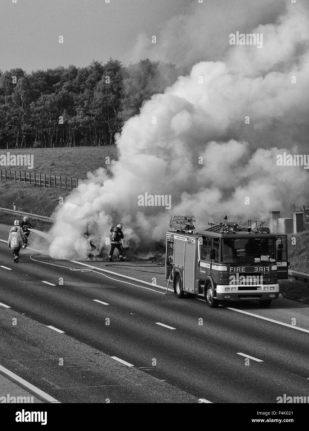 Firemen putting out a van fire on Motorway Stock Photo - Alamy