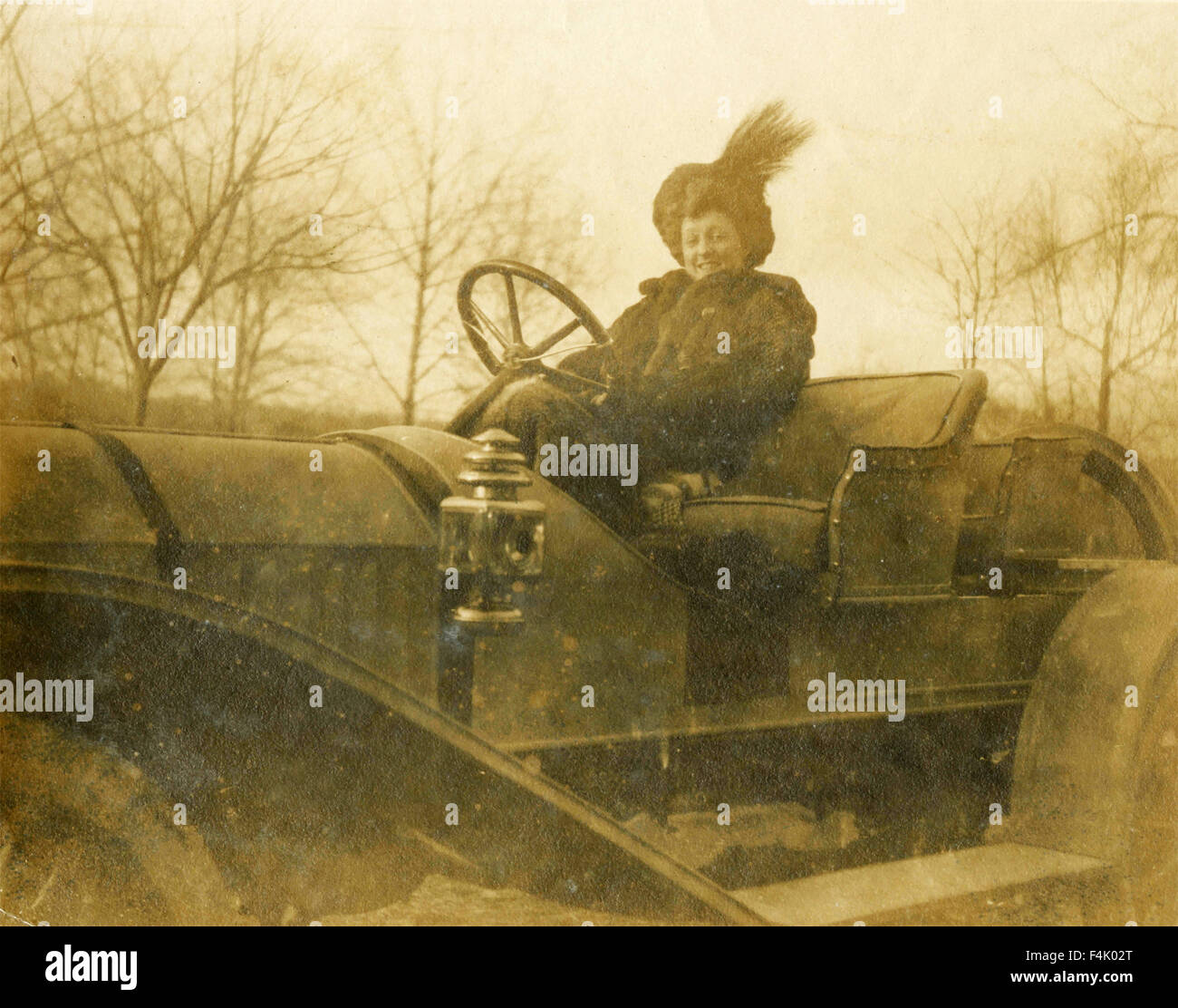 Lady driving a car with a hat with feathers hi-res stock photography ...