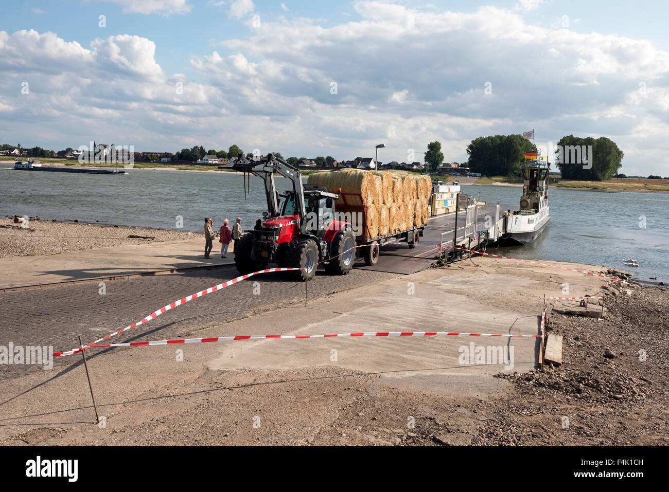 Tractor and trailer loaded with straw bales driving off the Hitdorf to ...