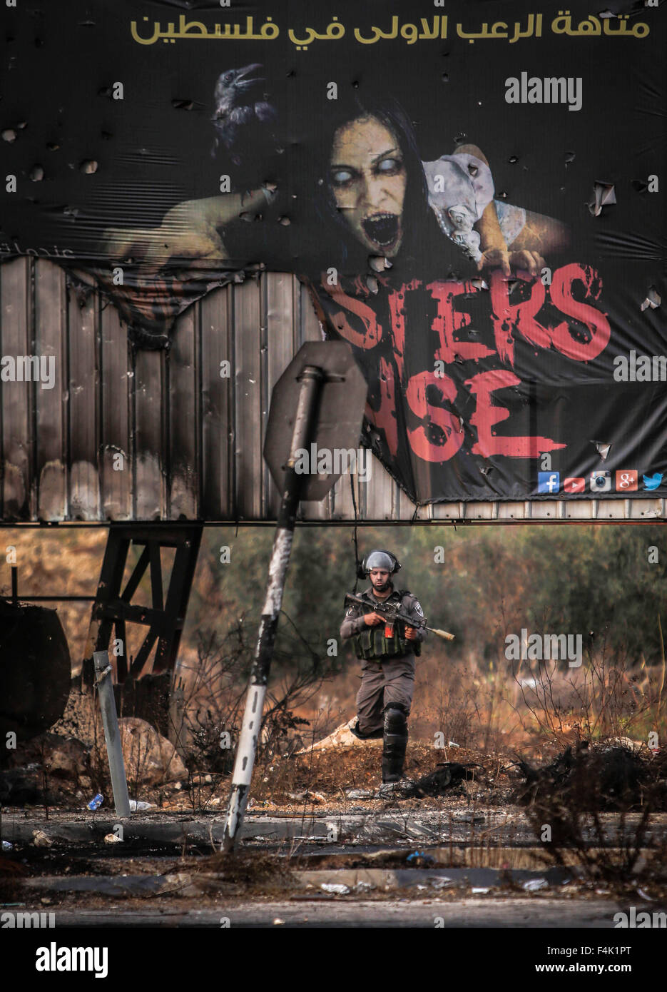 Oct. 19, 2015 - An Israeli soldier takes position under a billboard ...