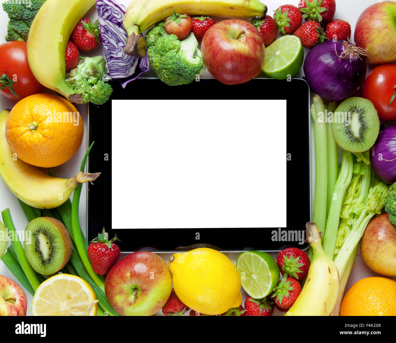 Fruits and vegetables around a computer tablet with an empty screen ...