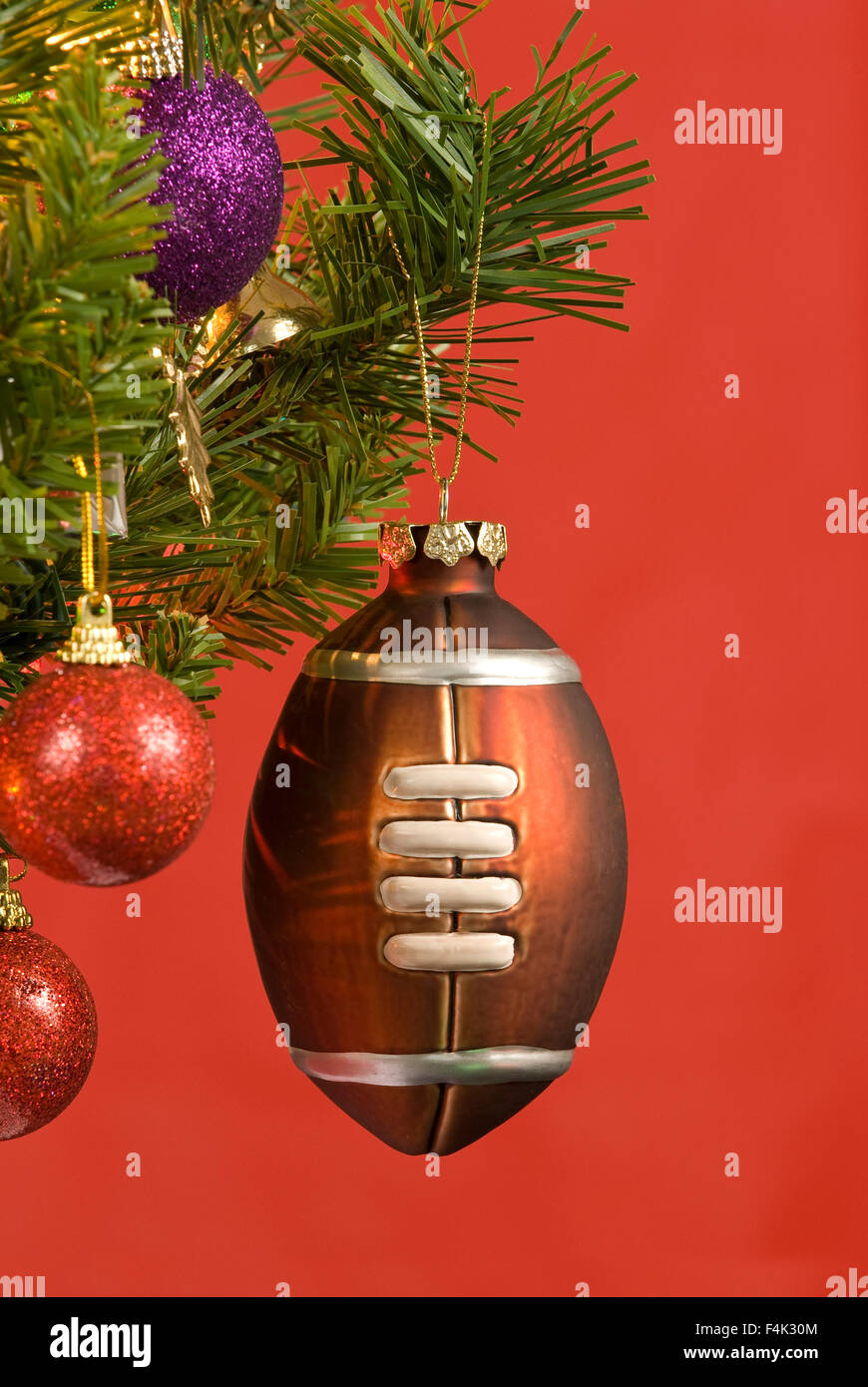 Football Christmas Ornament Hanging from a Christmas tree limb Stock ...