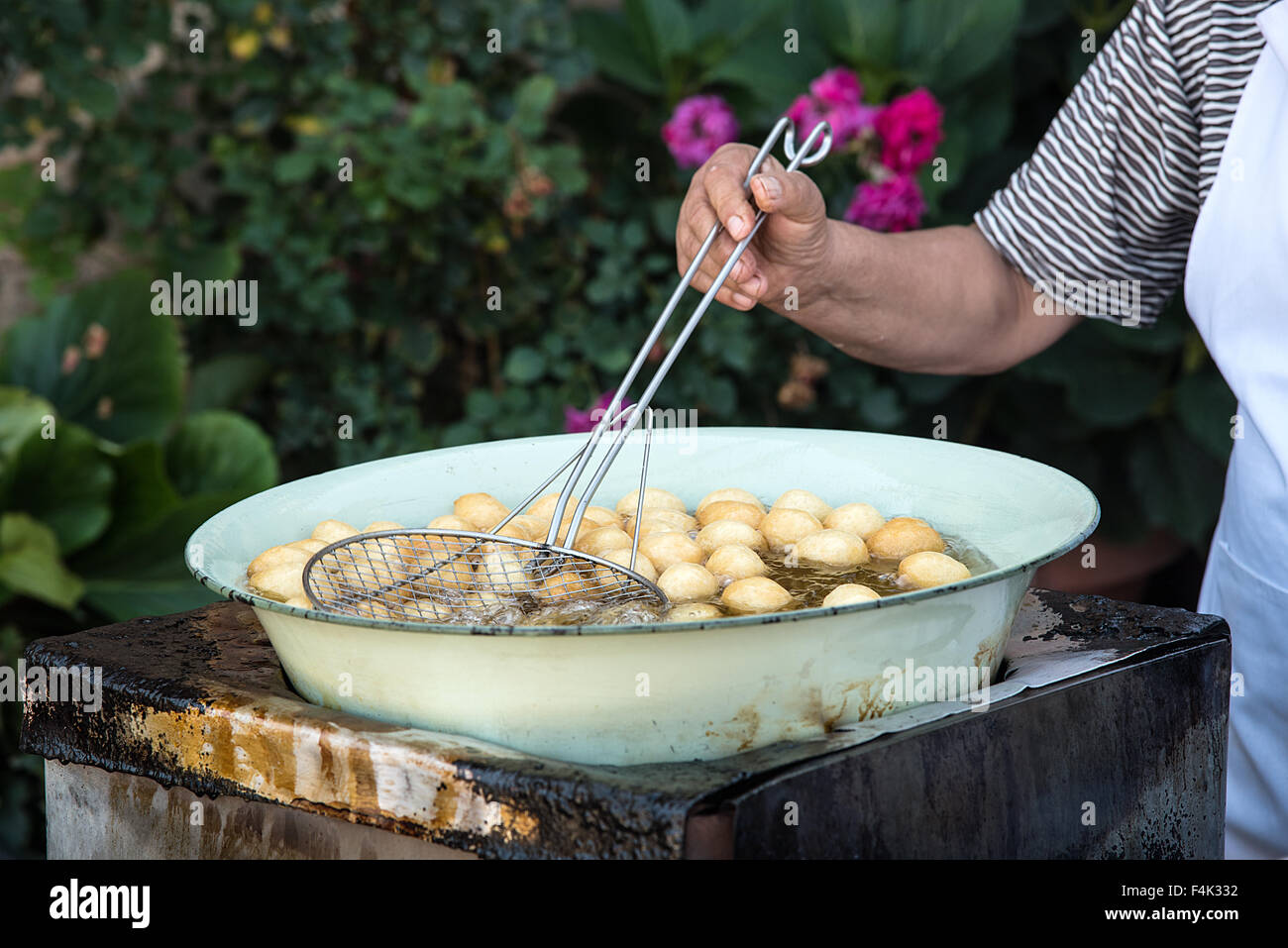 Woman cooking traditional delicious greek loukoumades honey pastry ...