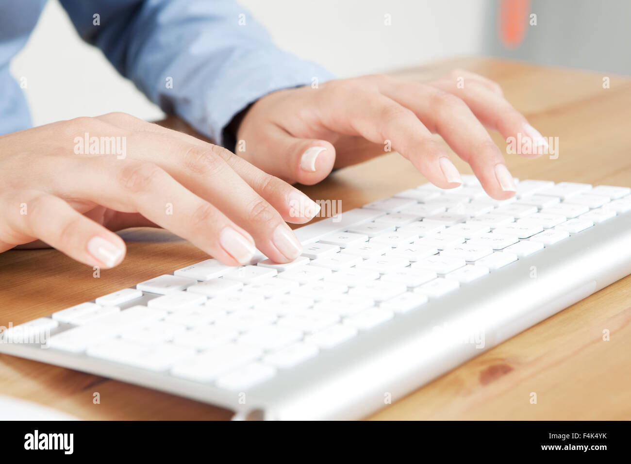 Female fingers typing on a keyboard at a desk, no face Stock Photo - Alamy