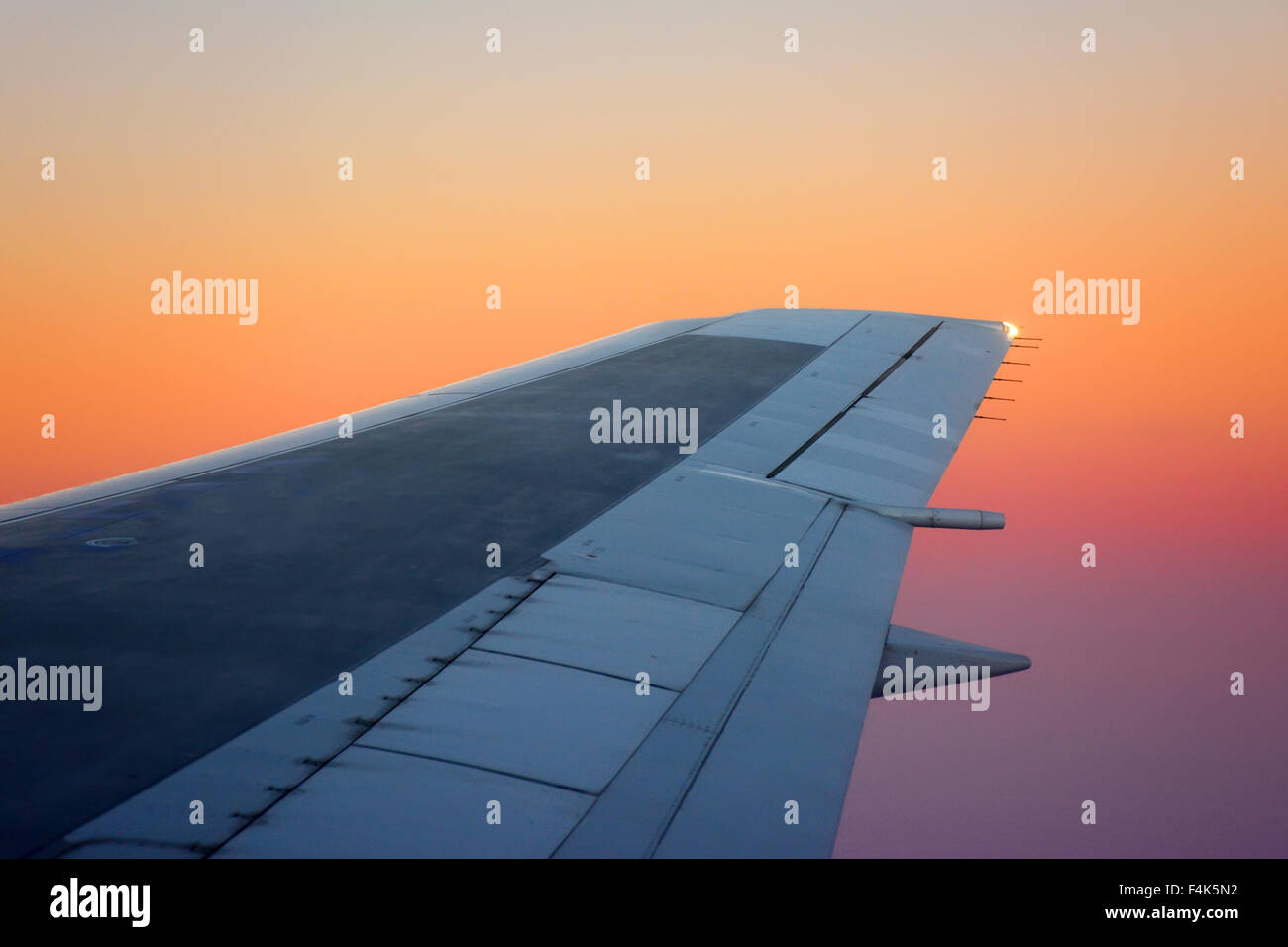 Airplane wing on sunset Stock Photo - Alamy