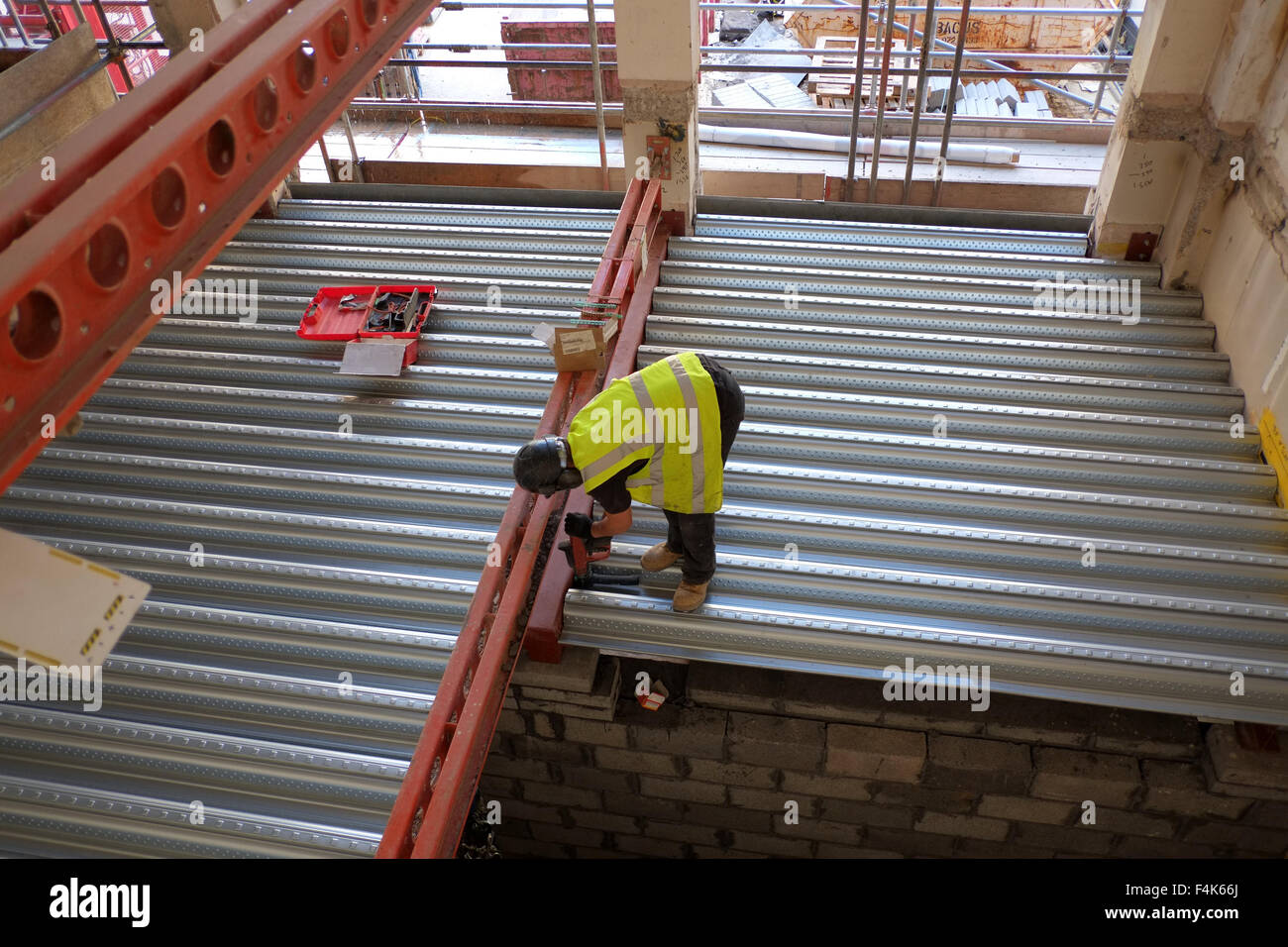 Builder working on a metal floor Stock Photo - Alamy