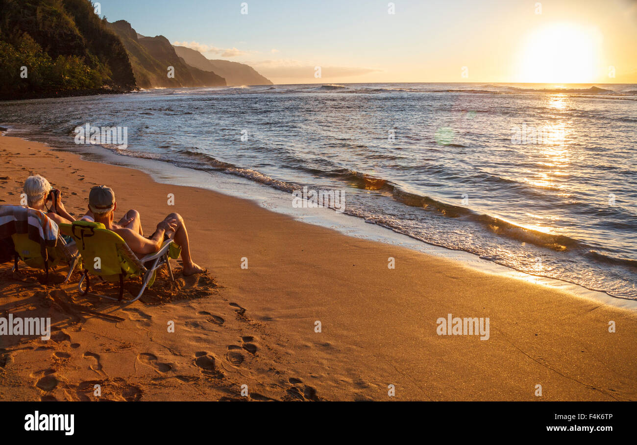 People at Kee Beach see sunset and the Na Pali Coast Stock Photo - Alamy