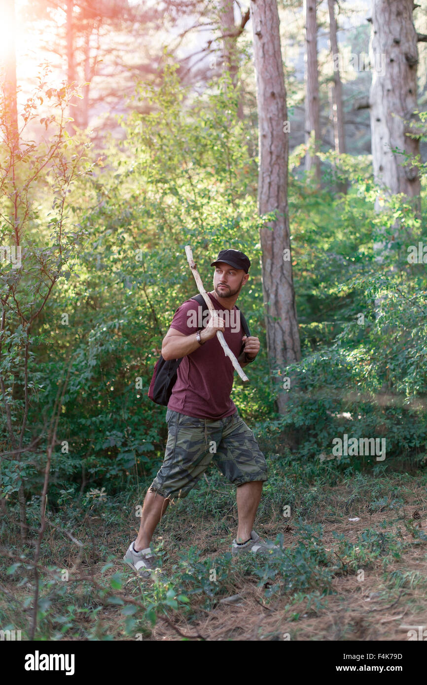 Man with hiking equipment walking in mountain forest Stock Photo - Alamy