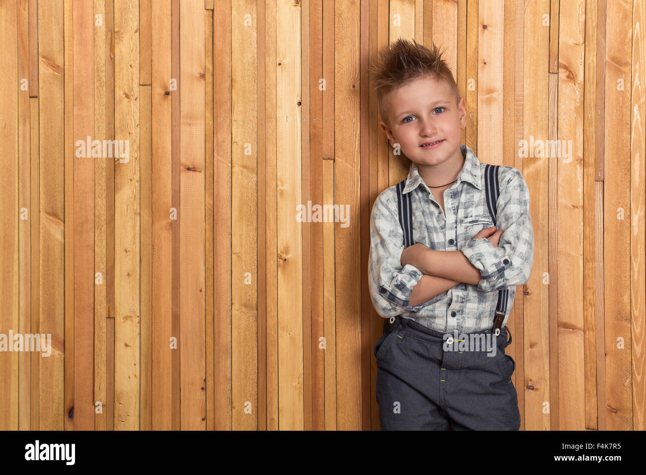 Boy model in the studio on wooden background Stock Photo - Alamy
