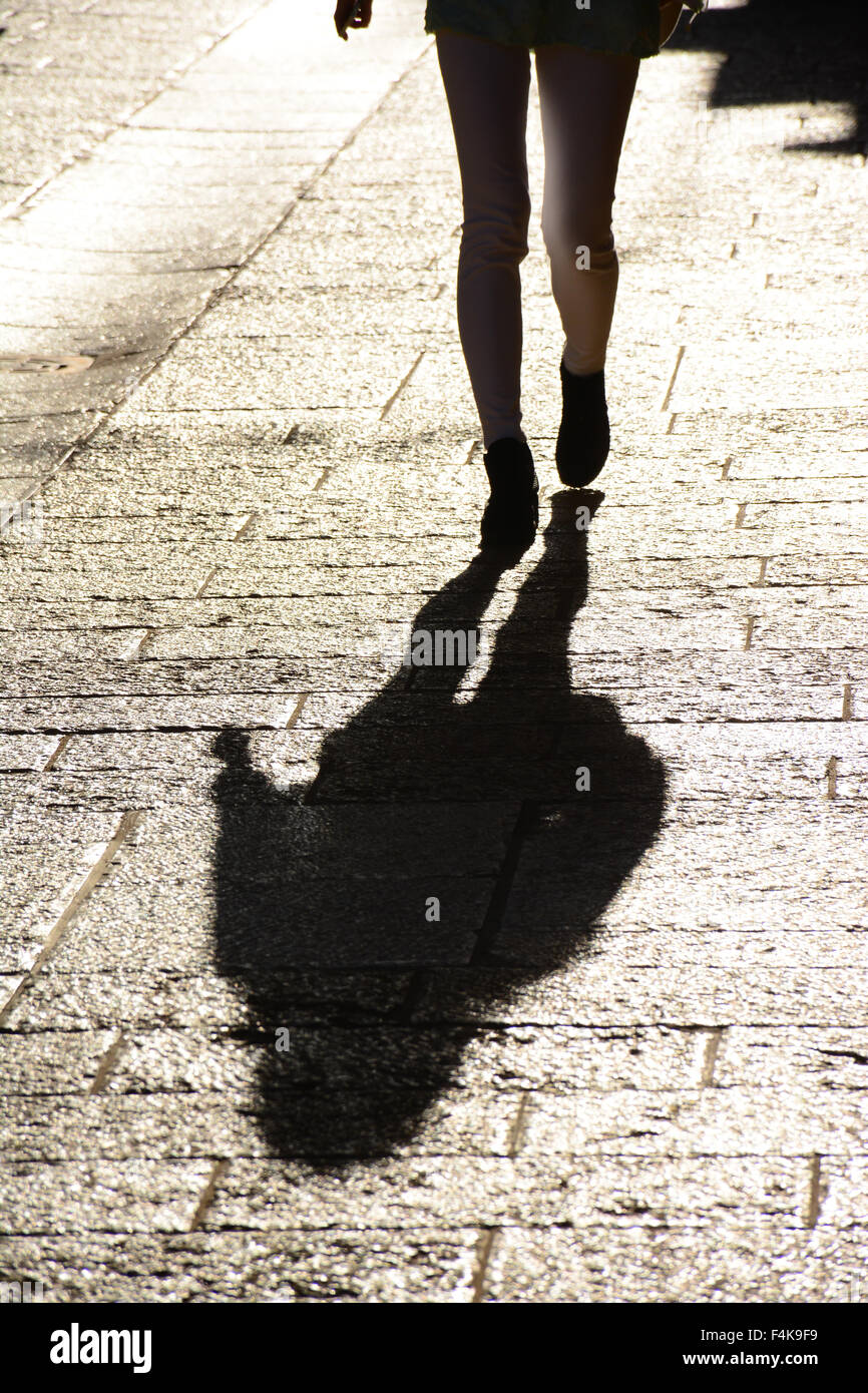 Walking woman shade Stock Photo - Alamy