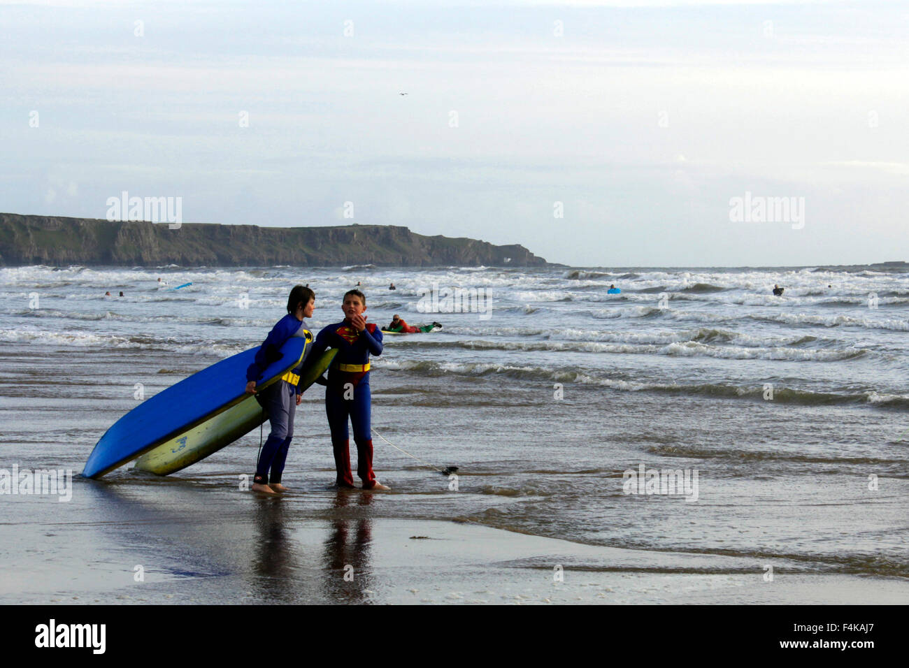 Boys surfing on Rhossili beach, Gower, Wales Stock Photo - Alamy
