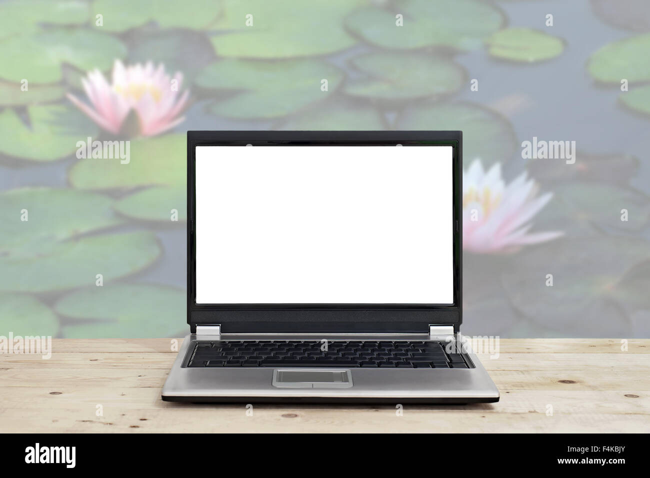 laptop with blank screen on wooden table with lotus flower background ...
