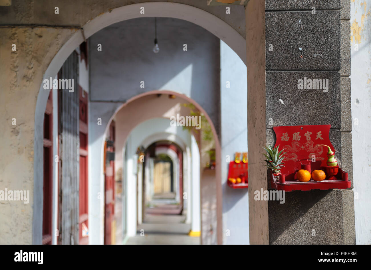 Chinese praying altar hooked on the pillar Stock Photo - Alamy
