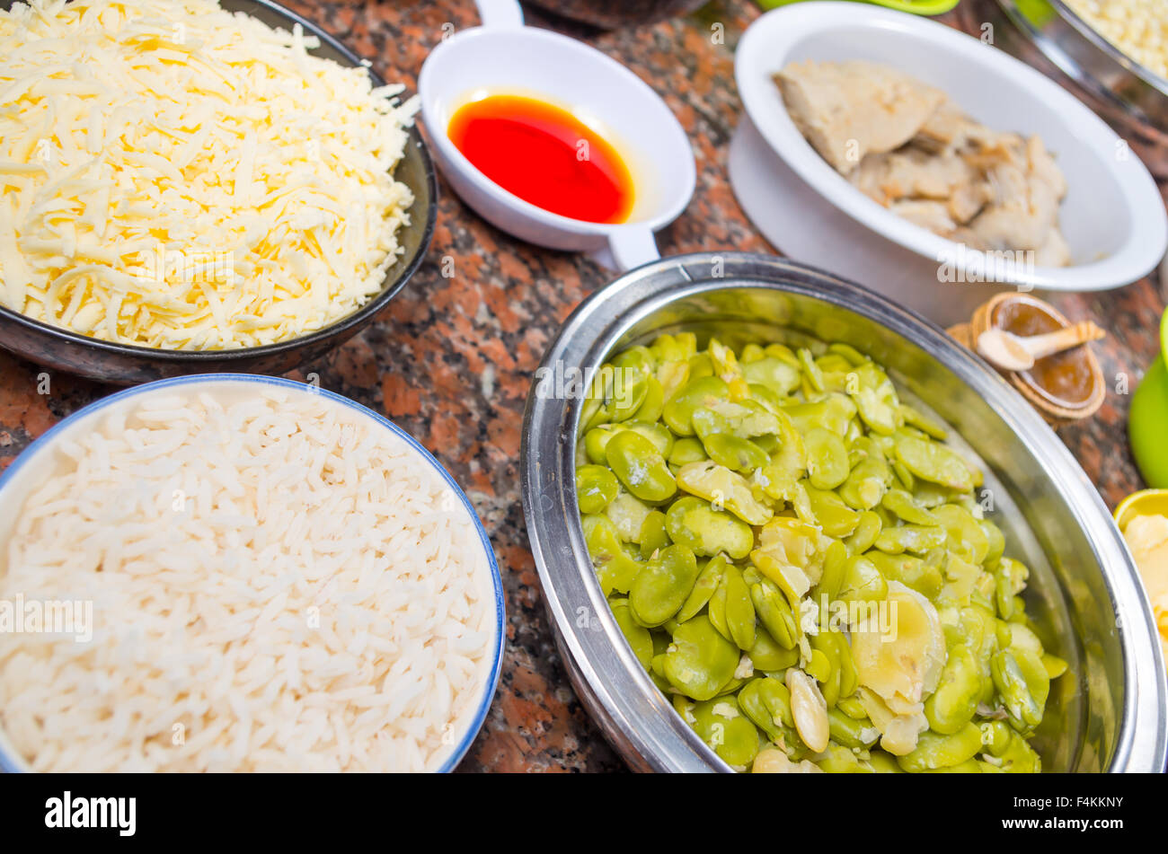 Bowls of different ingredients spread out on granite surface including ...