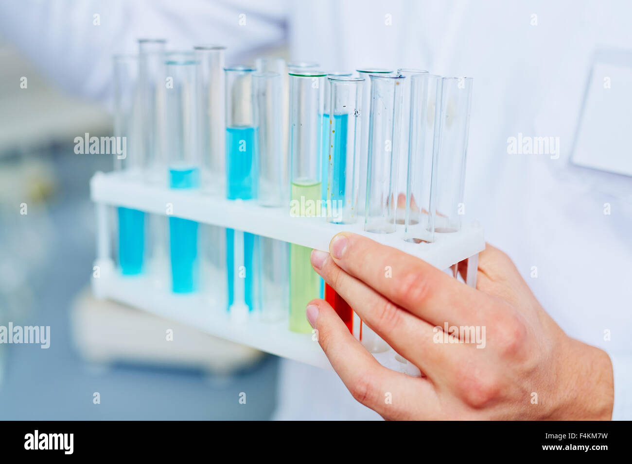 Flasks with substances in chemist hands Stock Photo - Alamy