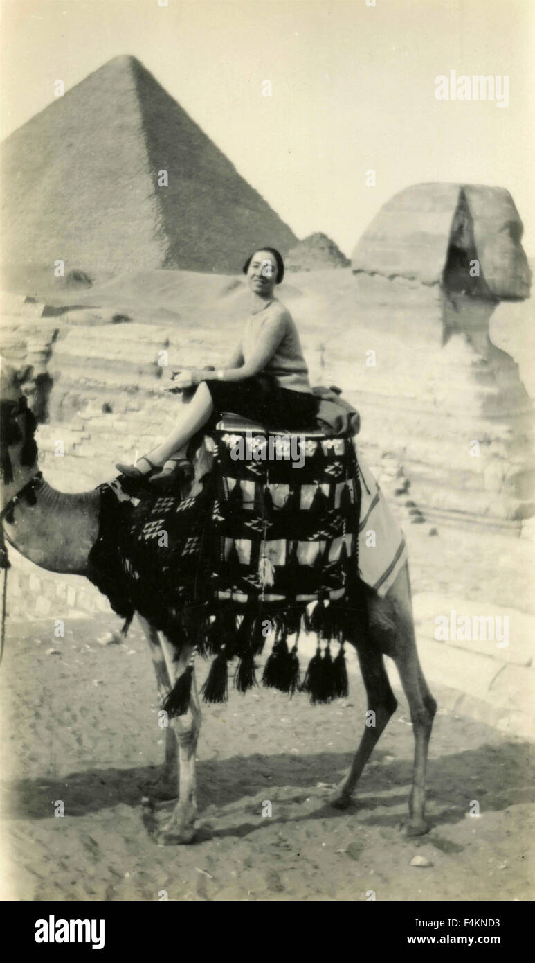 Woman on camel with pyramids and sphinx background, Egypt Stock Photo ...