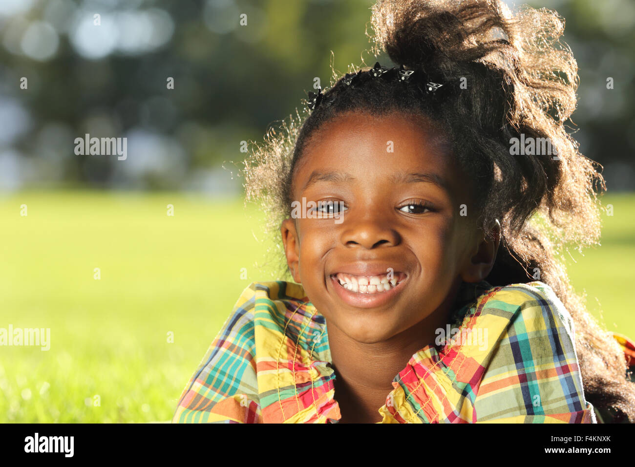 Happy child relaxing in a park Stock Photo - Alamy