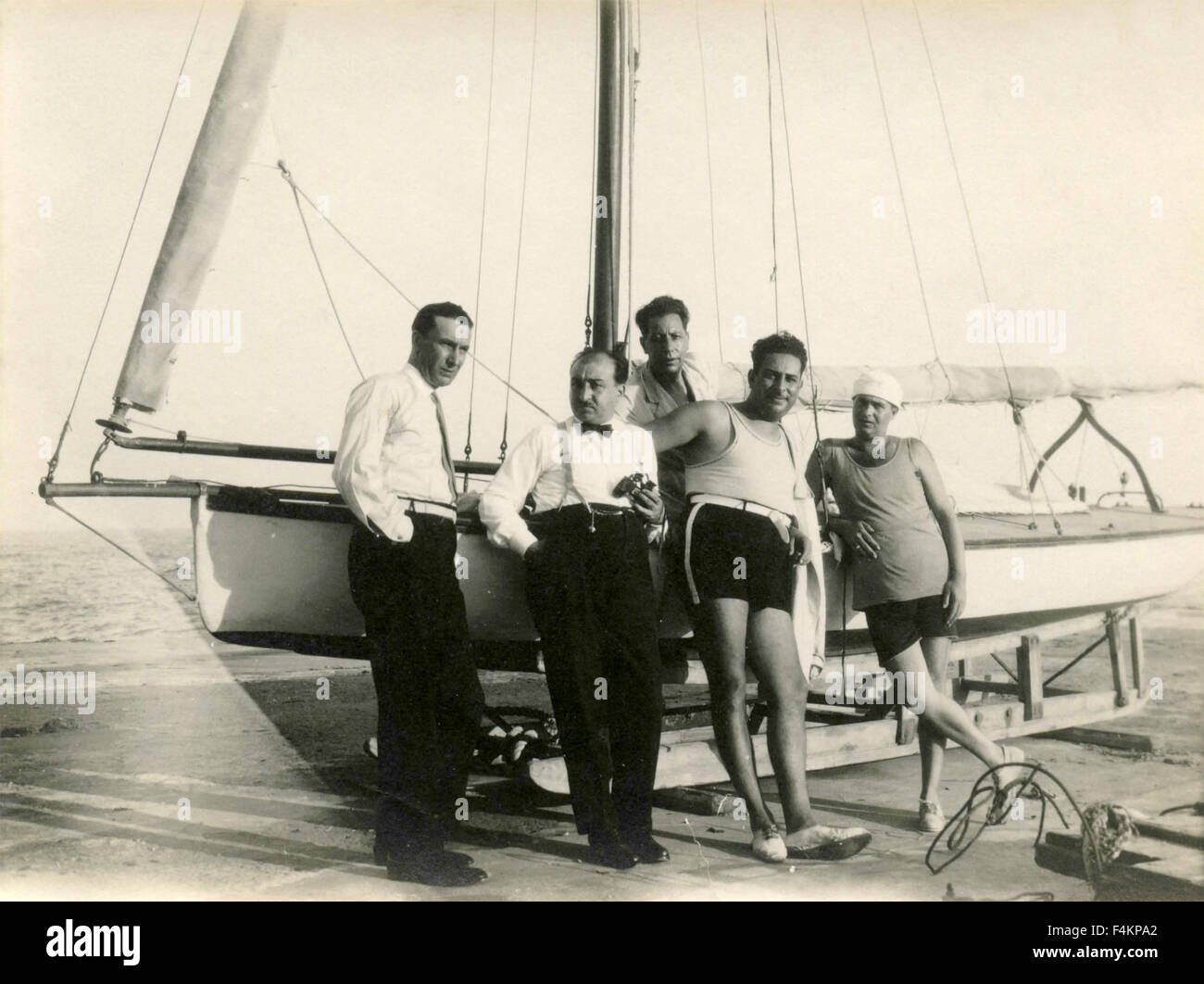 Group Of Friends Around A Sailing Boat High Resolution Stock ...