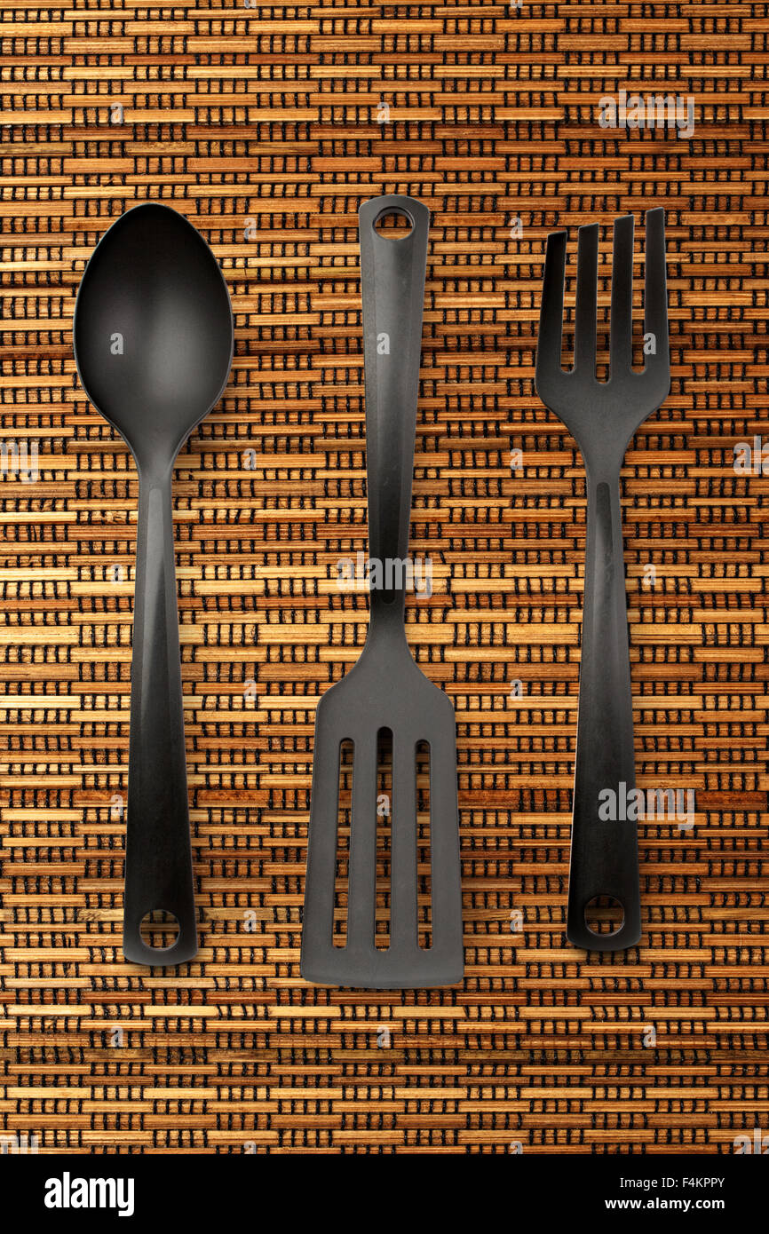 Kitchen utensil collection on straw textured background Stock Photo - Alamy