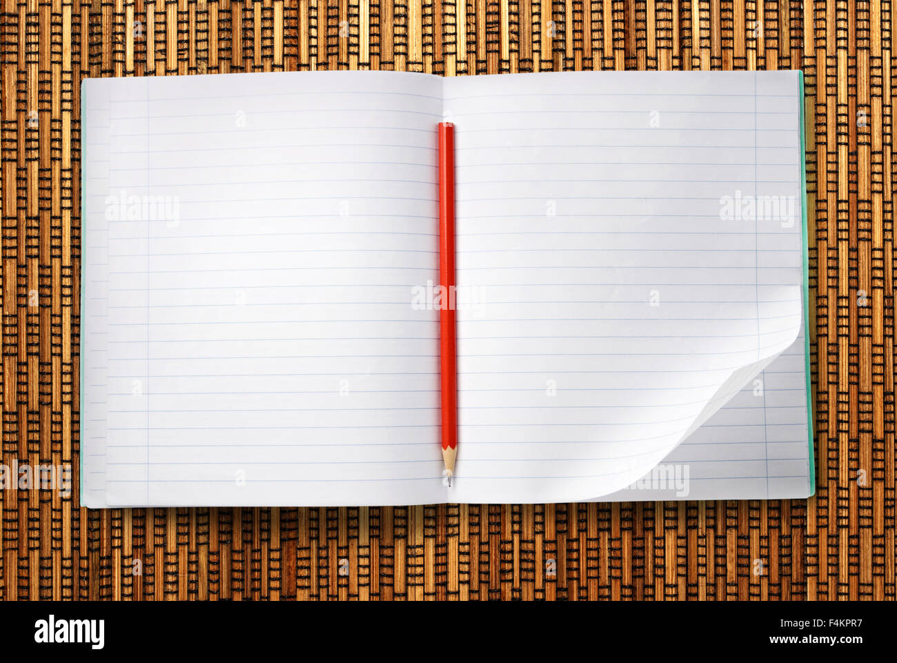 Blank open notebook with red pencil closeup Stock Photo - Alamy