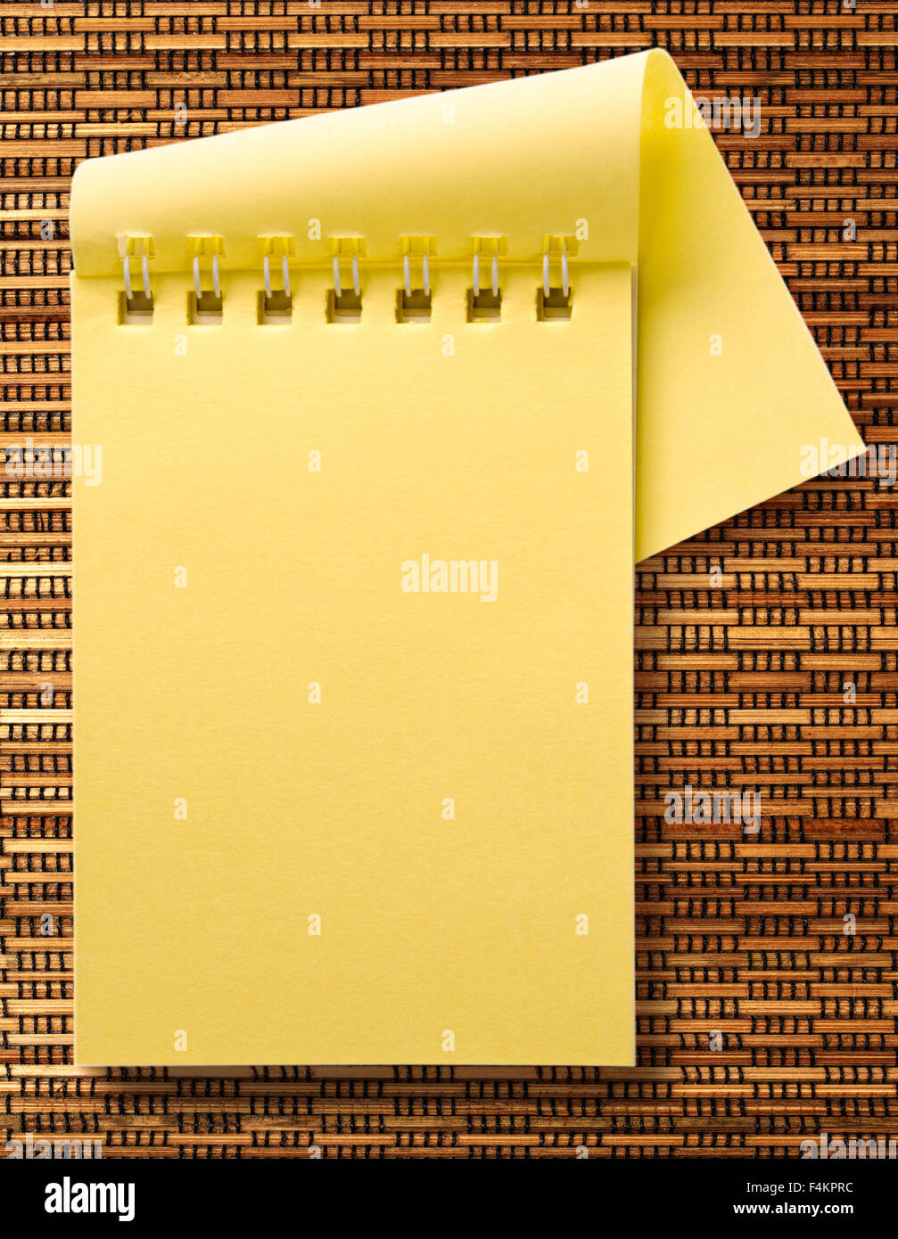 Yellow notepad on the textured background Stock Photo - Alamy