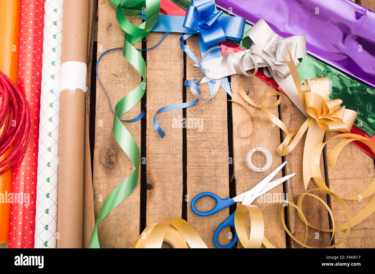 Gift wrapping concept with various paper colors, scissors, tape and ...