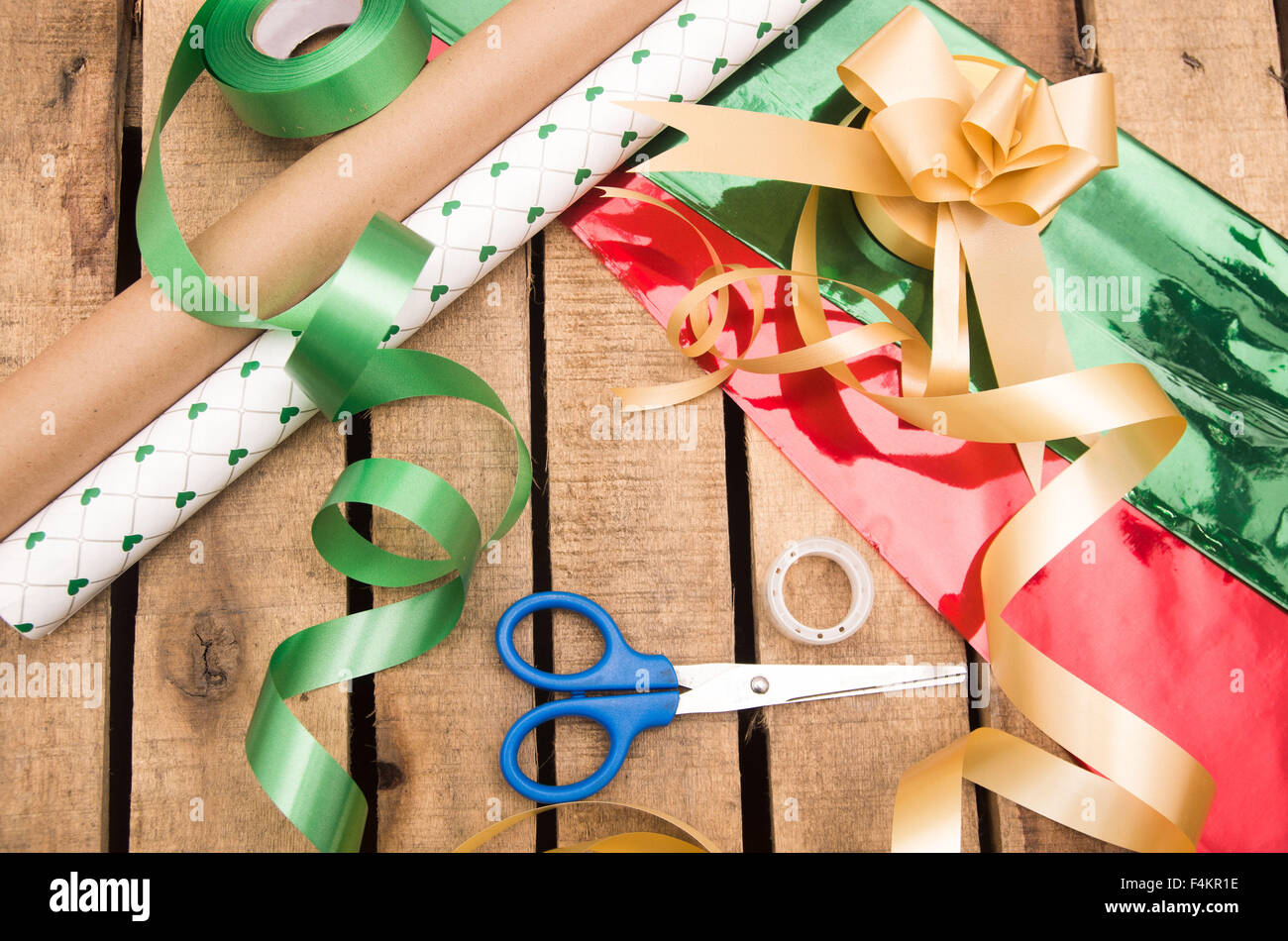 Gift wrapping concept with various paper colors, scissors, tape and ...