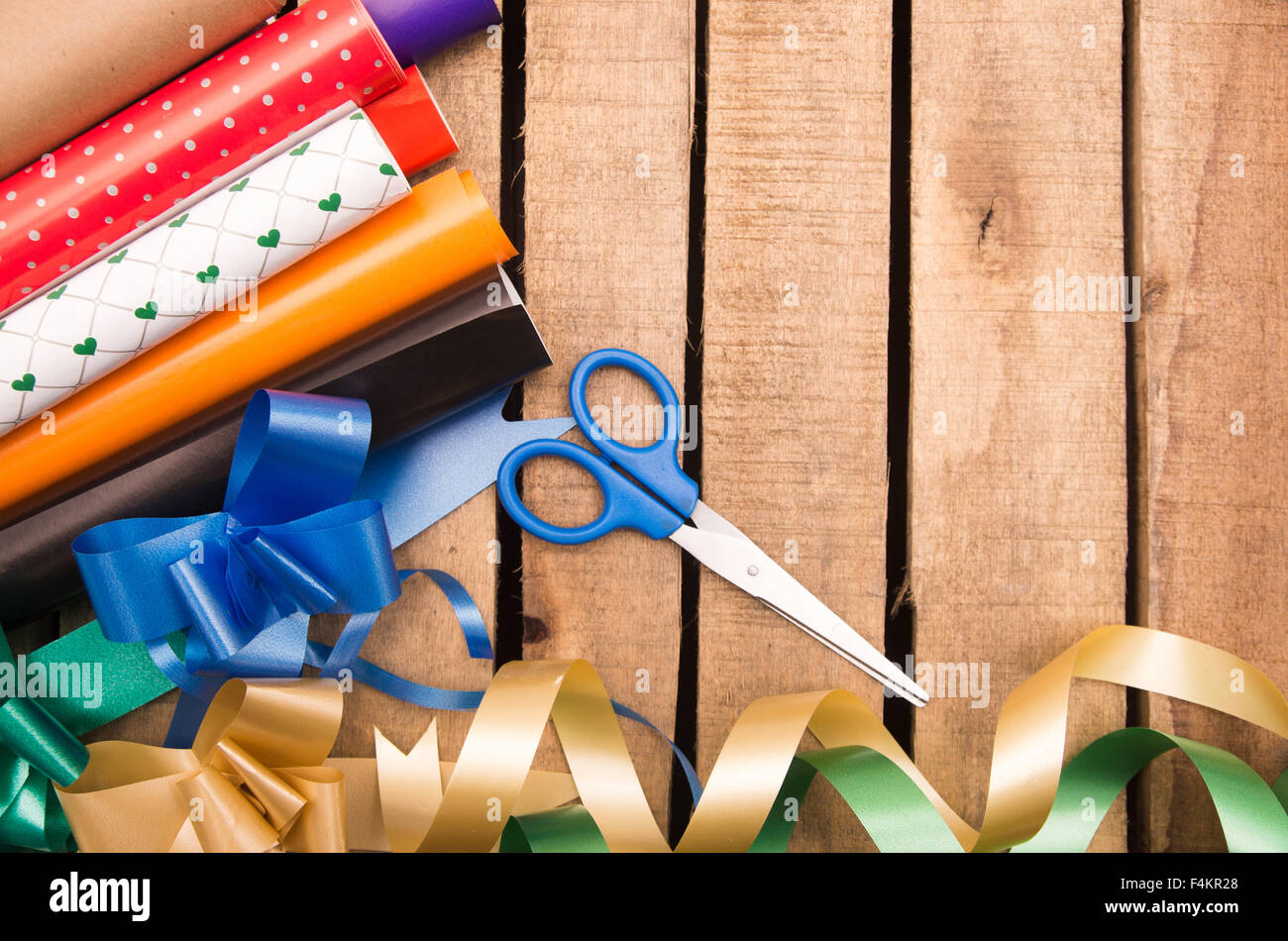 Gift wrapping concept with various paper colors, scissors, tape and ...