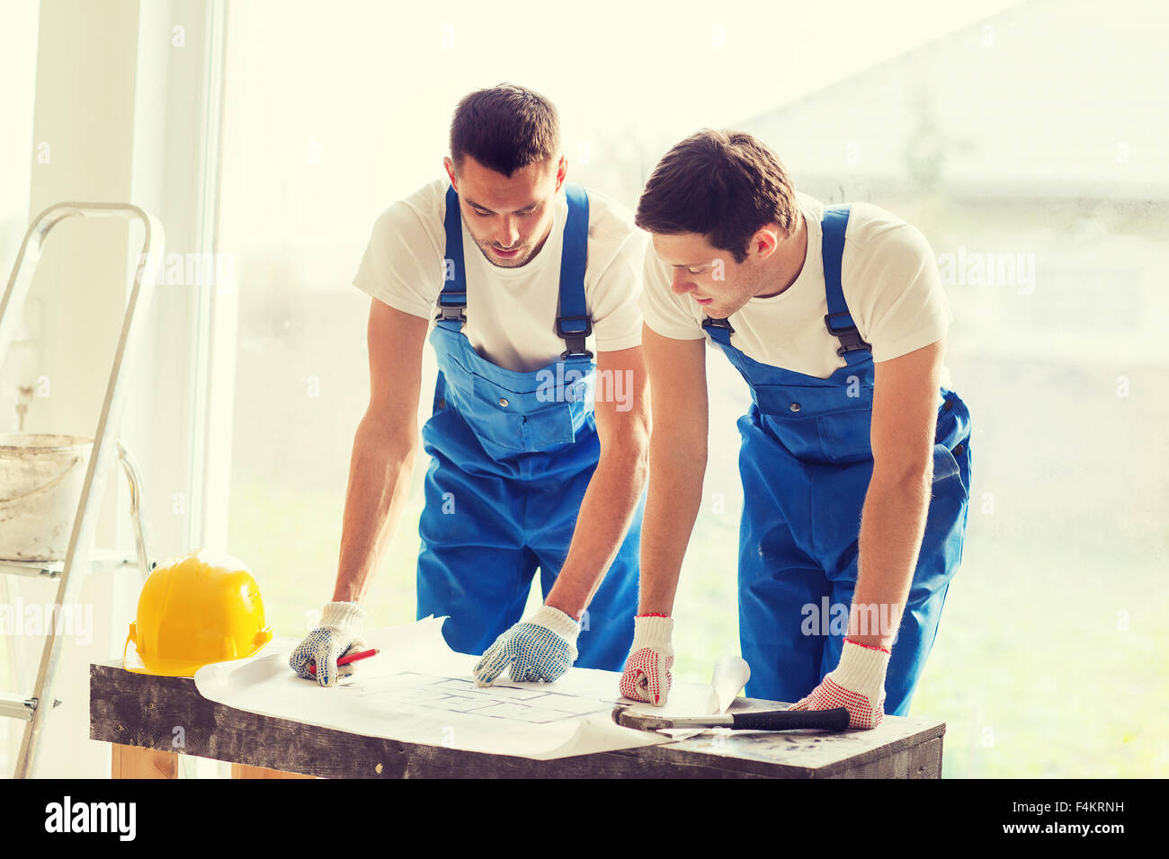 group of builders with blueprint Stock Photo - Alamy