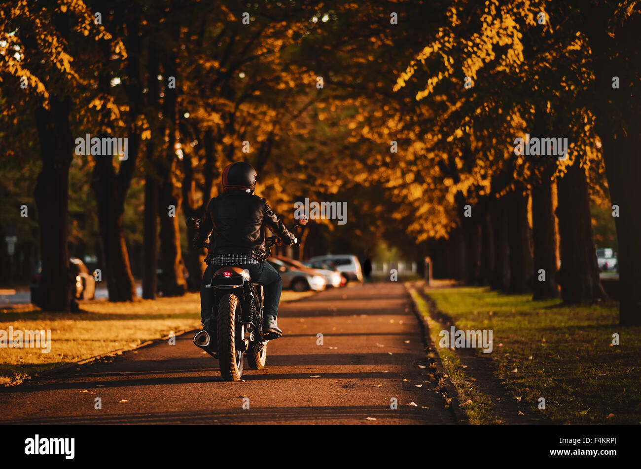Man riding a cafe-racer motorcycle Stock Photo - Alamy
