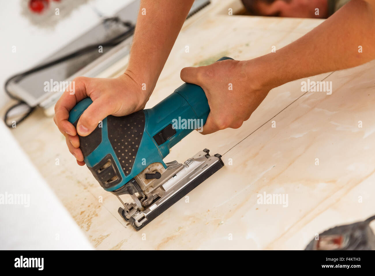 Installing new induction hob in modern kitchen Stock Photo - Alamy