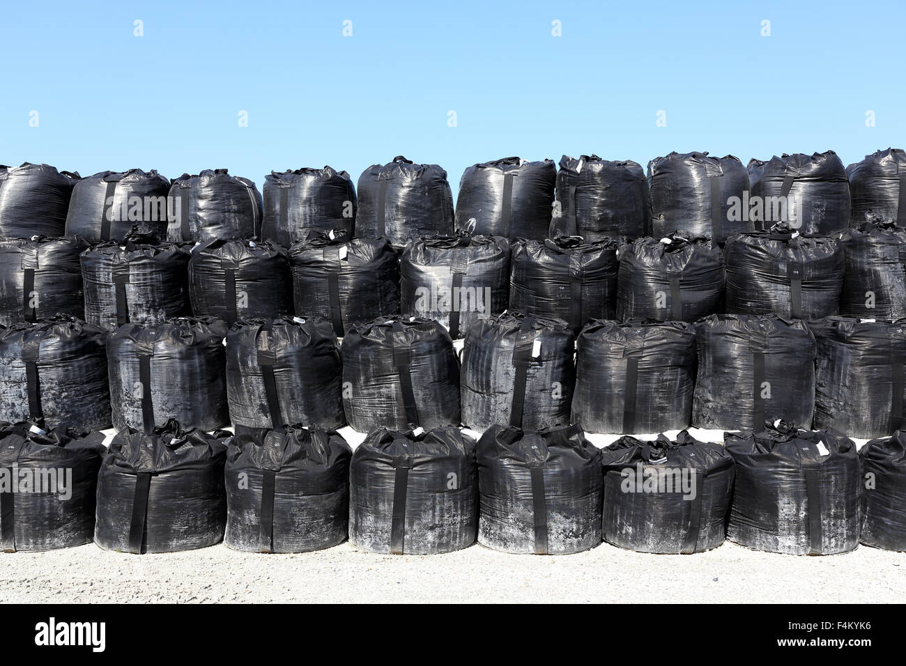 stack of toxic substance bag against a blue sky Stock Photo - Alamy