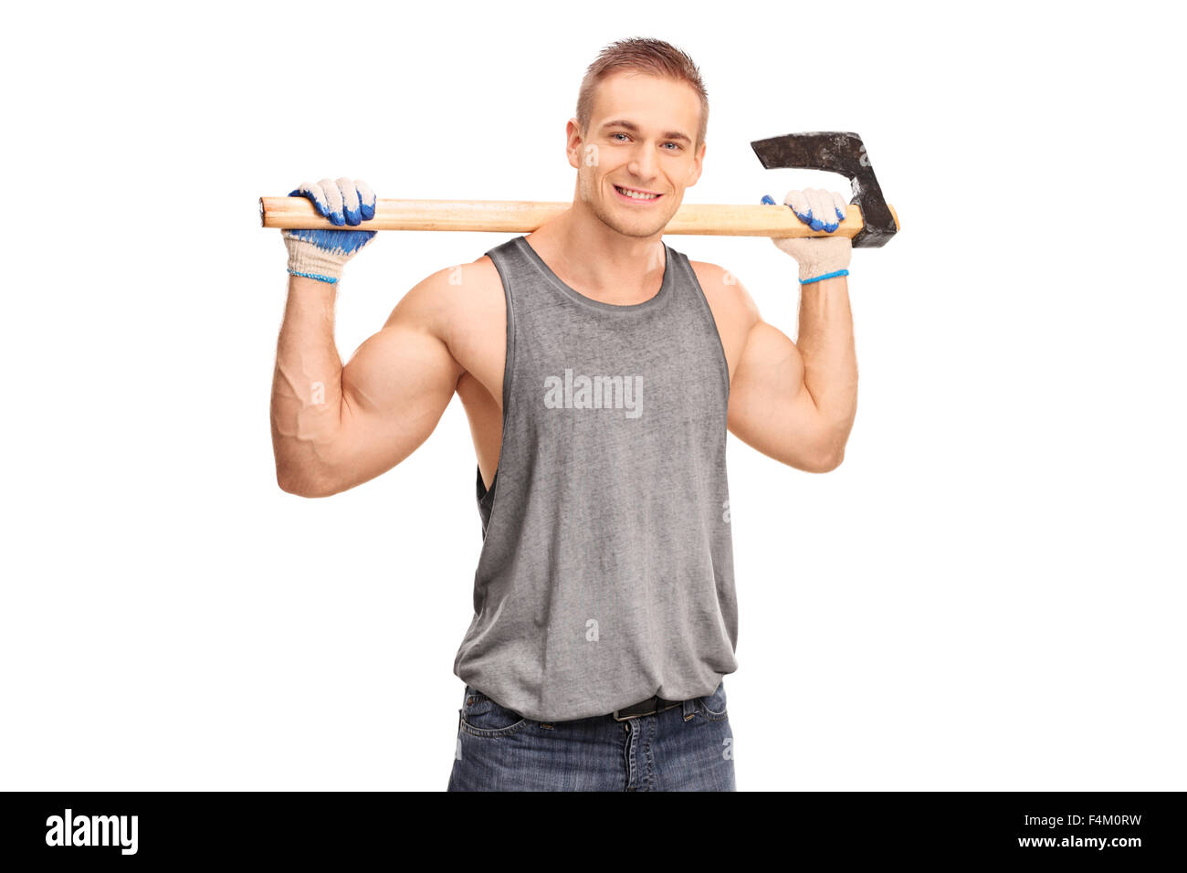 Handsome young logger carrying an ax on his shoulders and looking at ...